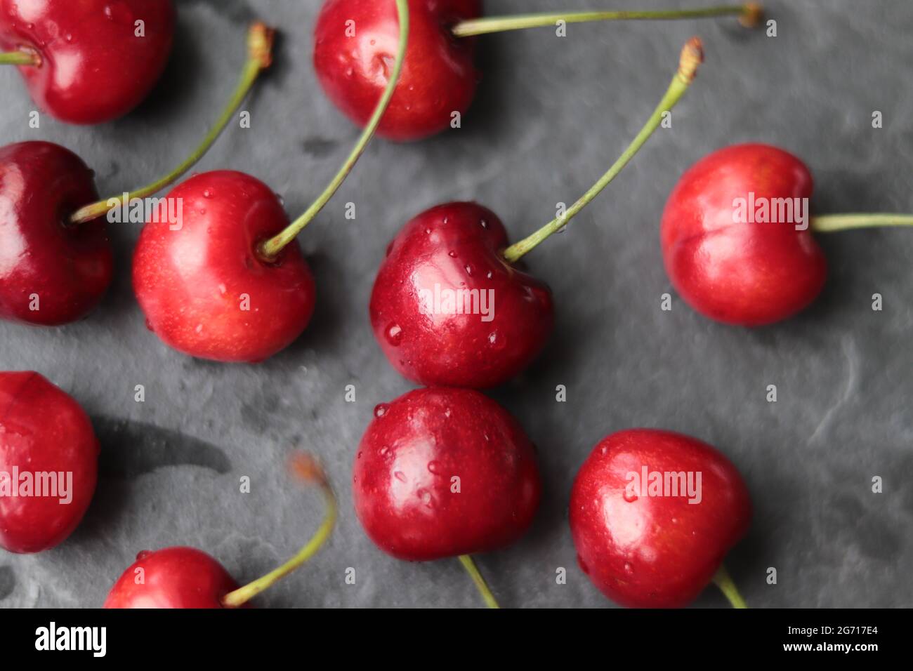 Top view of red glossy cherry with gray background Stock Photo - Alamy