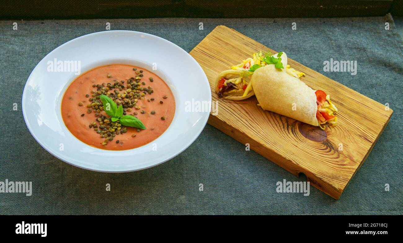 Puree soup and tacos on a wooden board Stock Photo - Alamy
