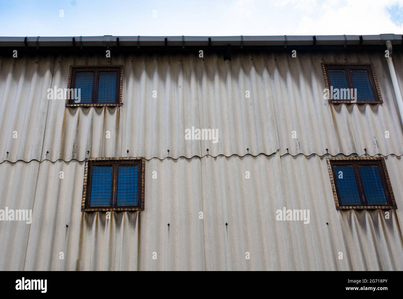 Low angle shot of a building facade with small windows Stock Photo - Alamy