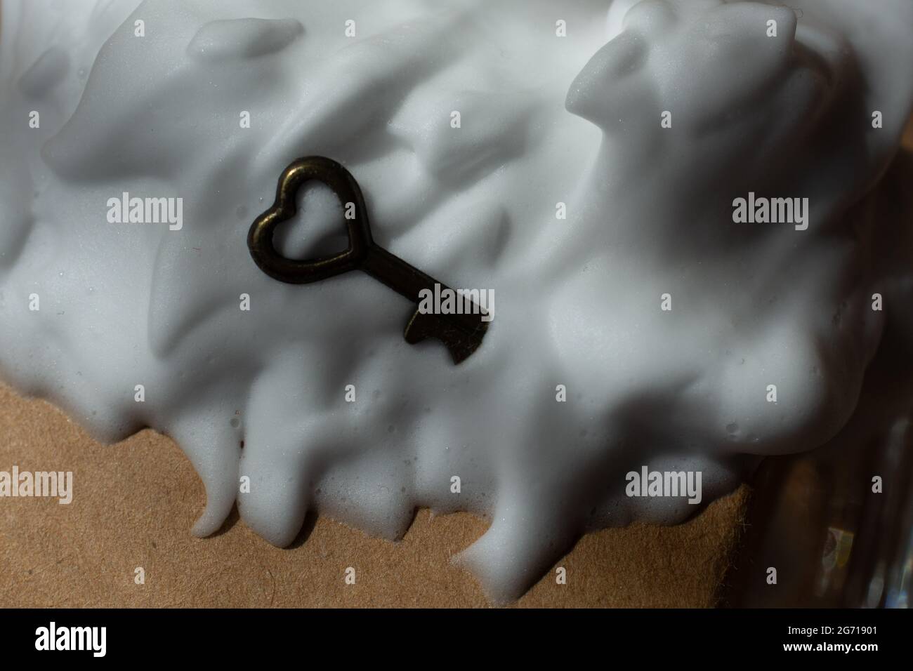 Heart-shaped key on foamy sea wave crashing to the sandy shore Stock ...