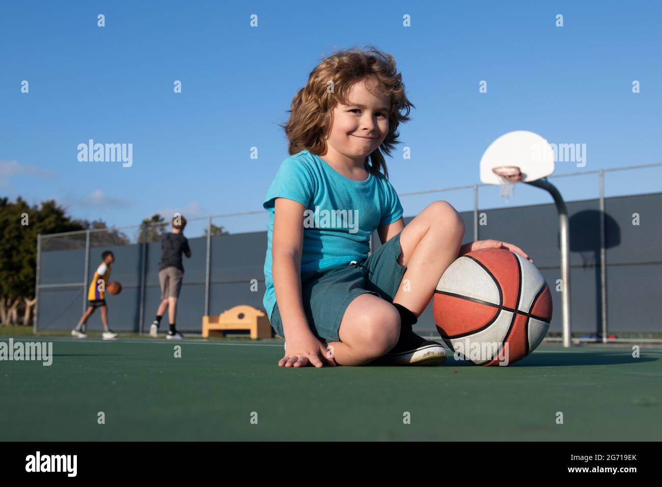 Happy little boy kid playing basketball on playground Stock Photo - Alamy