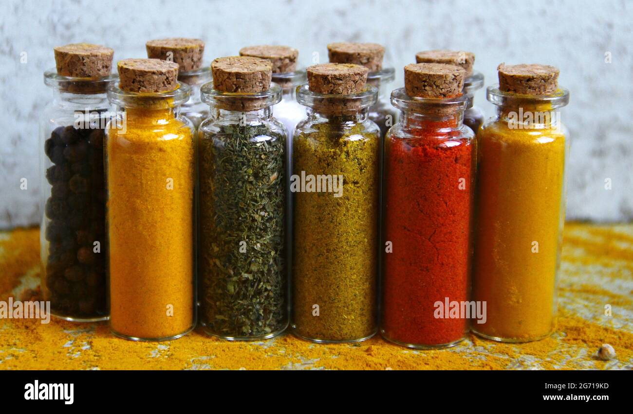 Vertical shot of various spices in small glass bottles Stock Photo - Alamy