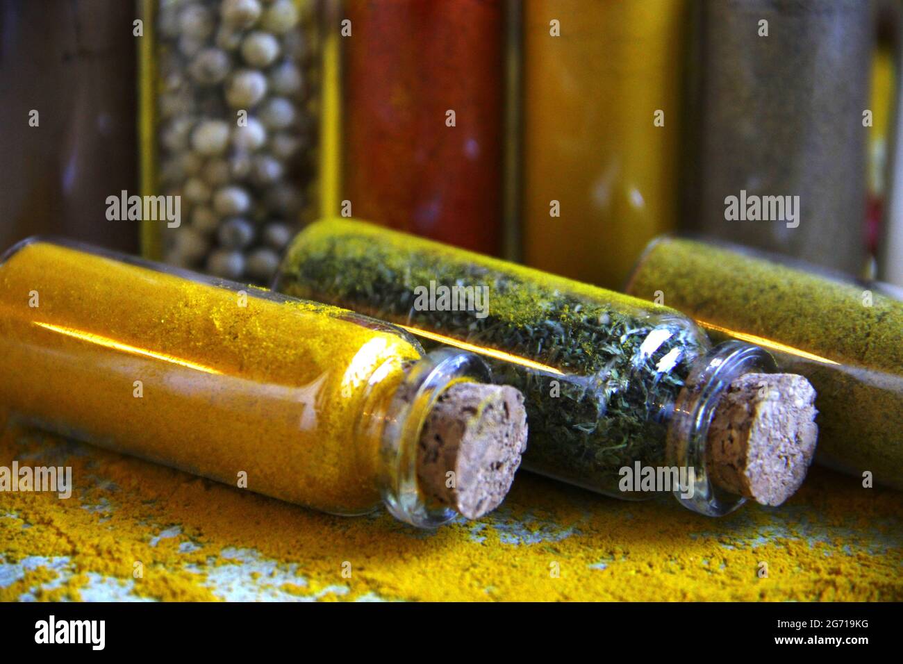 Close up shot of various spices in small laying glass bottles Stock ...