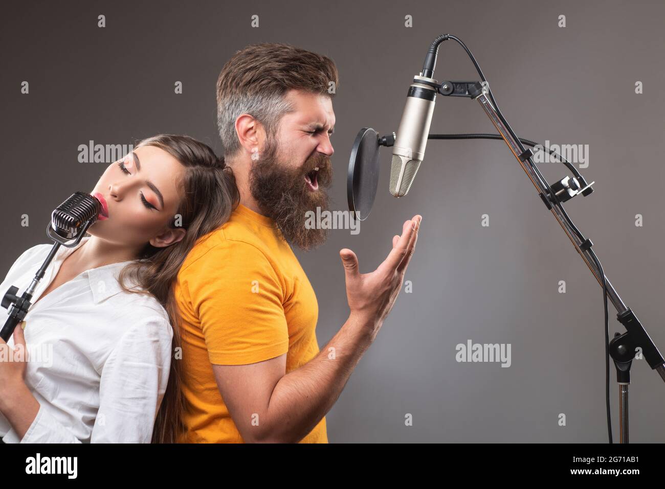 Couple singing. Coupl in recording studio. Music performance vocal ...