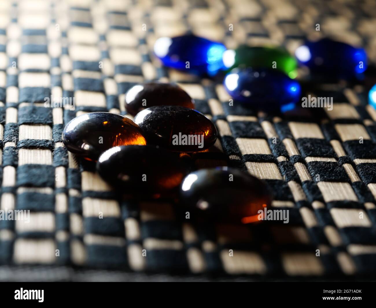 Closeup of radiant glass game board tokens on a checkered board with a ...
