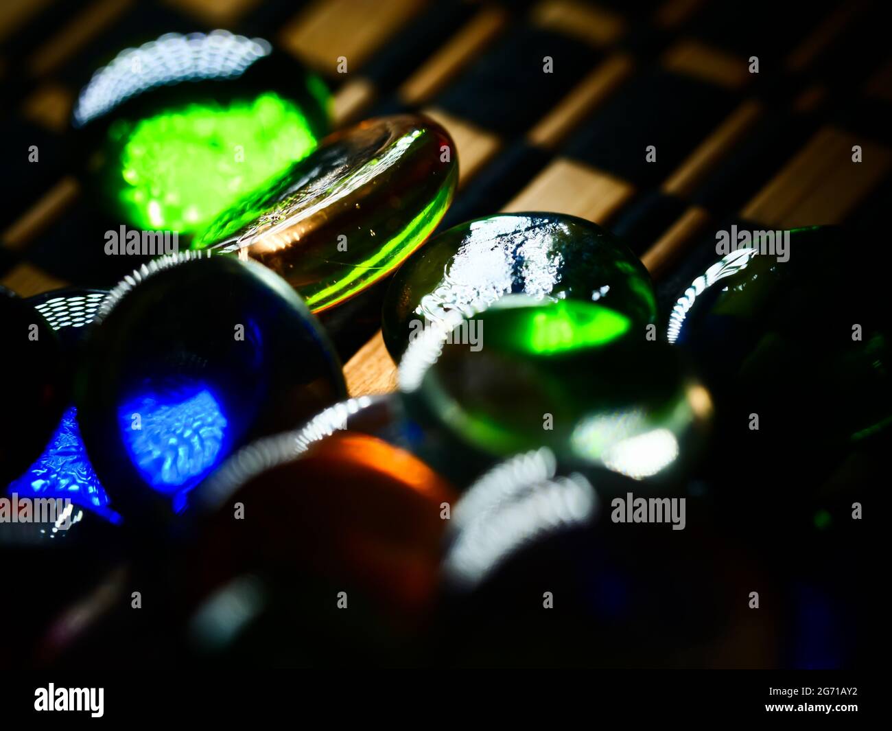 Macro shot of flat colorful board game tokens with neon lights ...