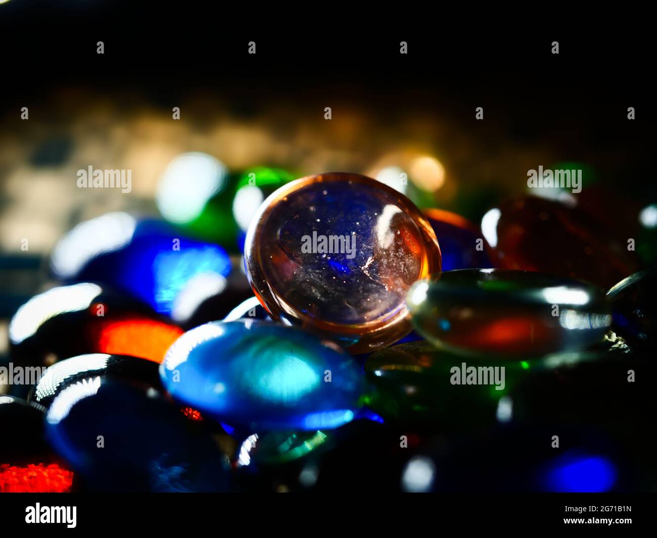 Closeup of flat circular gems with bright neon colors on a blurred ...
