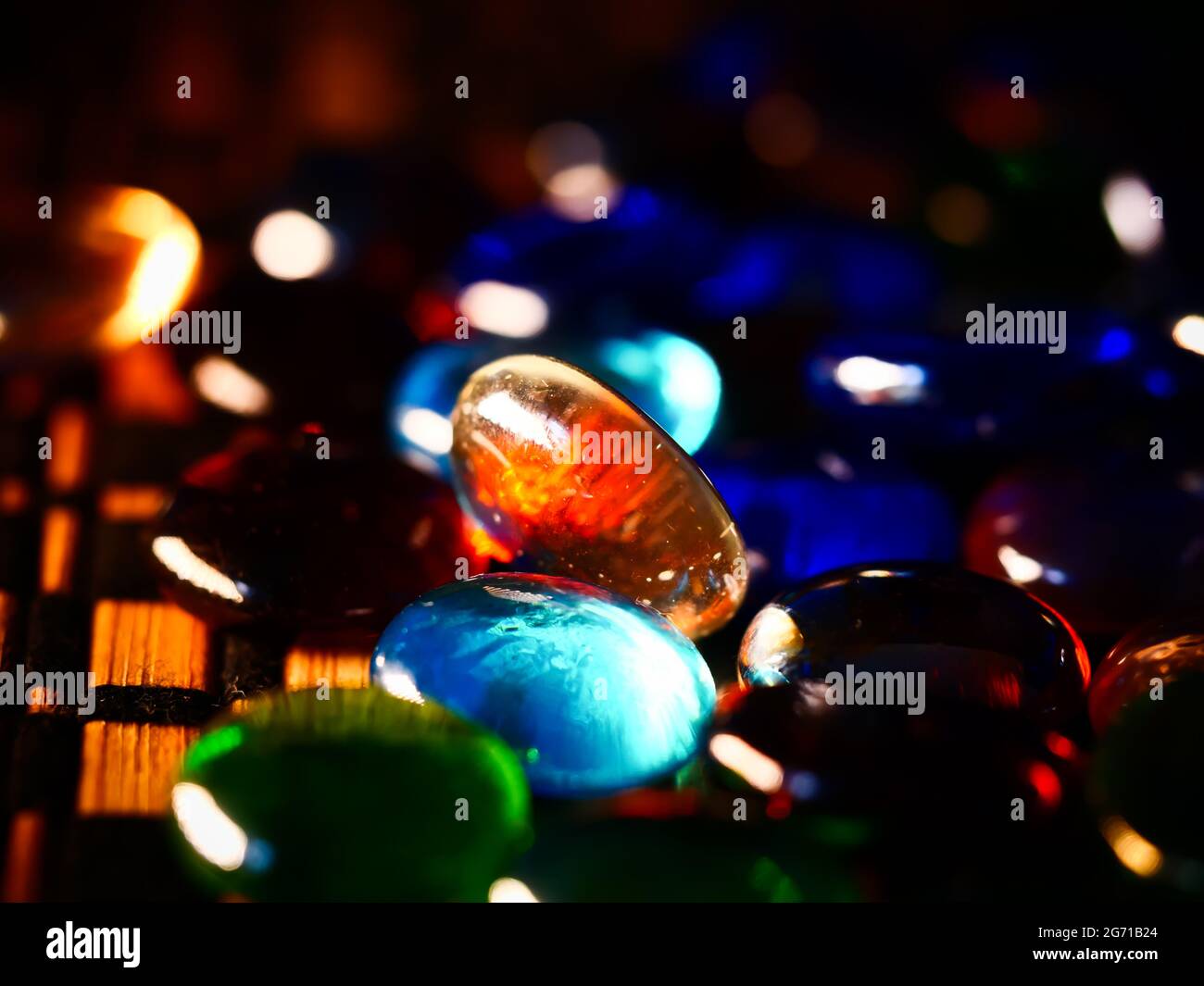 Closeup of clear circular board game tokens on a colorful blurry ...