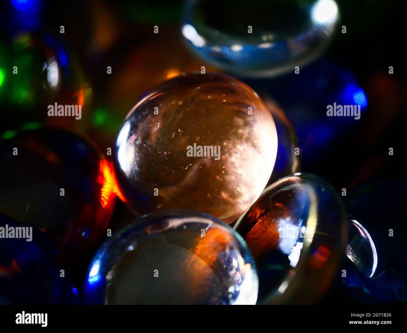 Closeup of a translucent orange gem surrounded by other gems on a ...