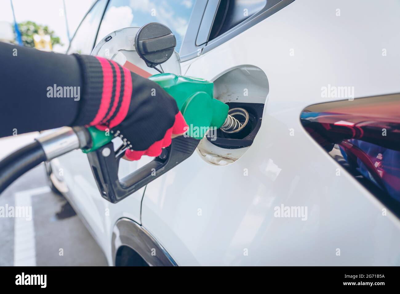Vehicle fueling facility at petrol station. White car at gas station ...