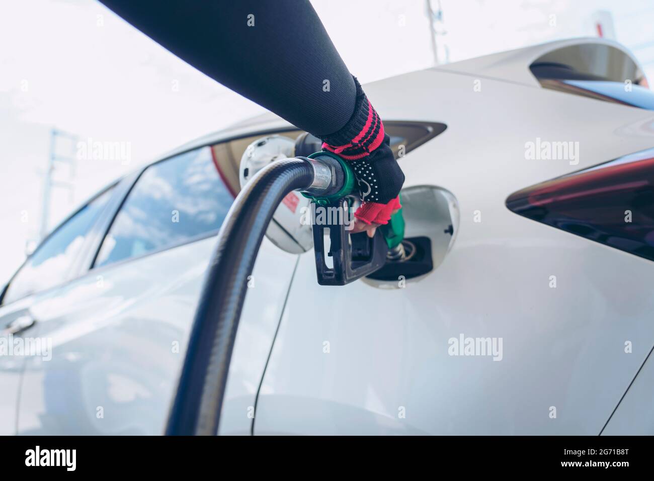 Vehicle fueling facility at petrol station. White car at gas station ...