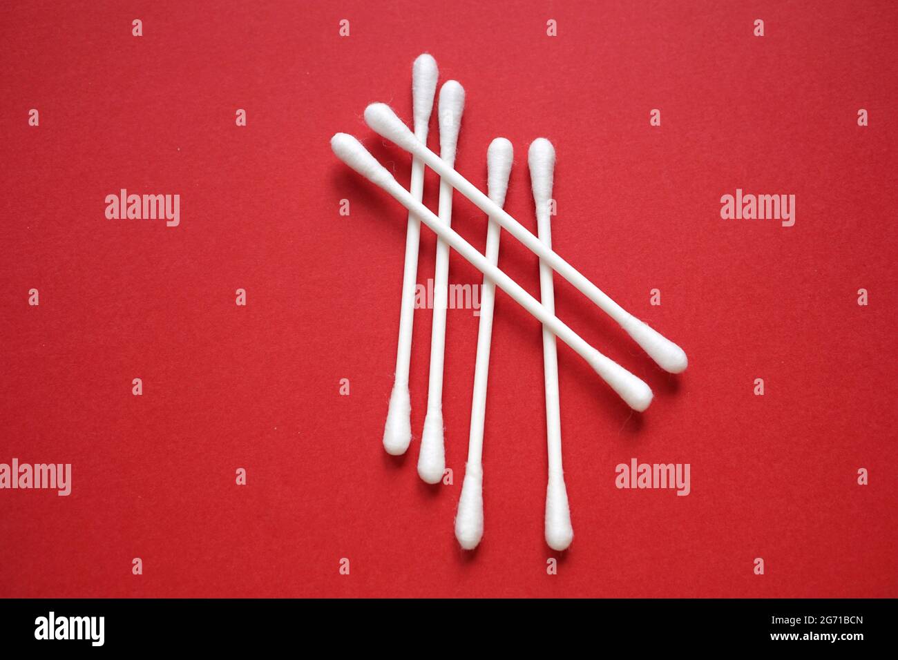 Ear sticks on a red background Stock Photo - Alamy