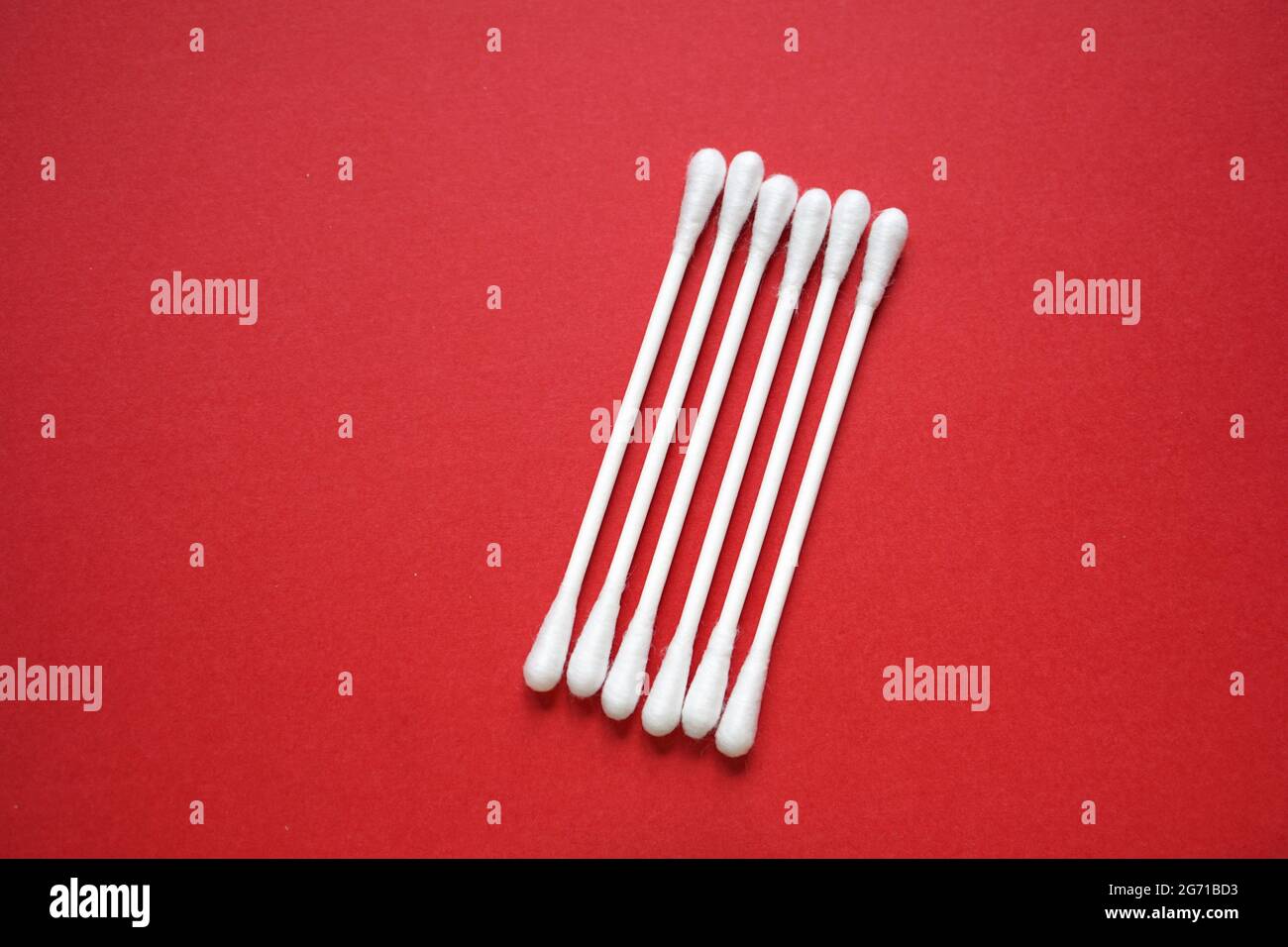 Ear sticks on a red background Stock Photo - Alamy