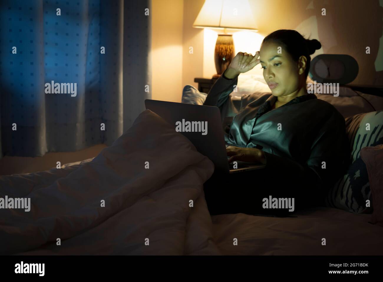 Focus on laptop. woman people in robe using smart cellphone.Sad ...