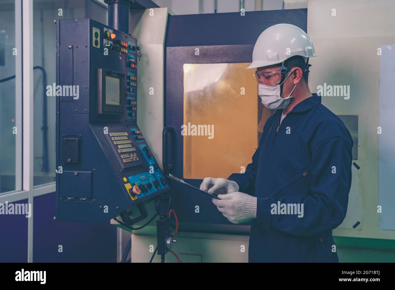 Male industrial engineer or technician worker wear face mask with ...