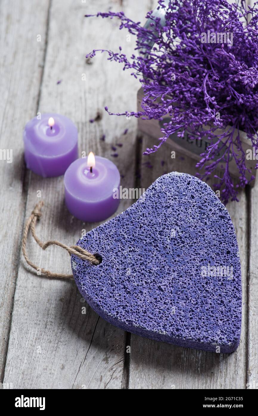SPA still life, Purple pumice closeup with violet flowers on wooden ...