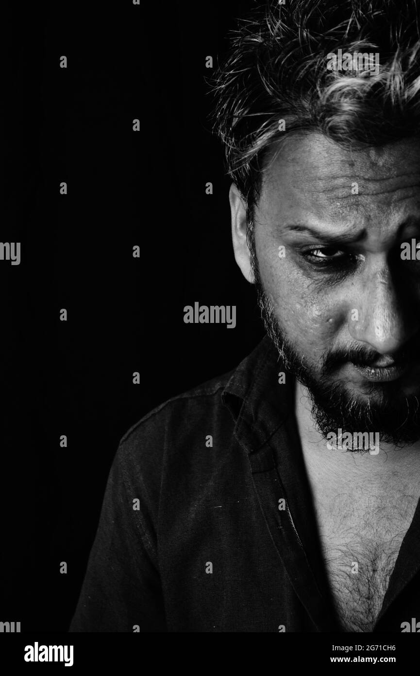 Grayscale portrait of a half-face of a man with an angry expression ...