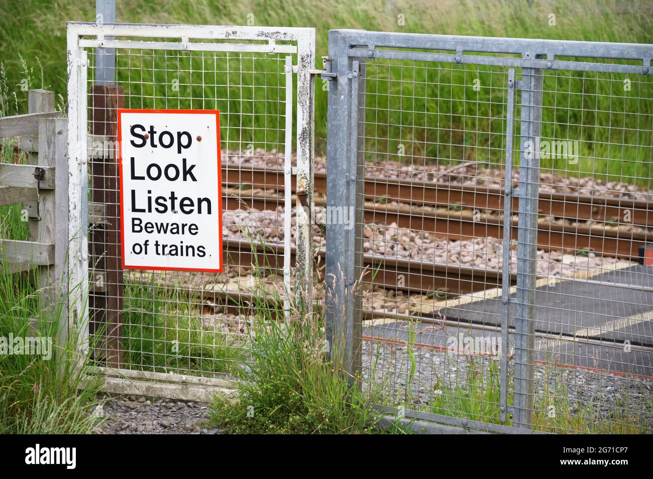Stop look listen safety road sign at railway train station danger ...