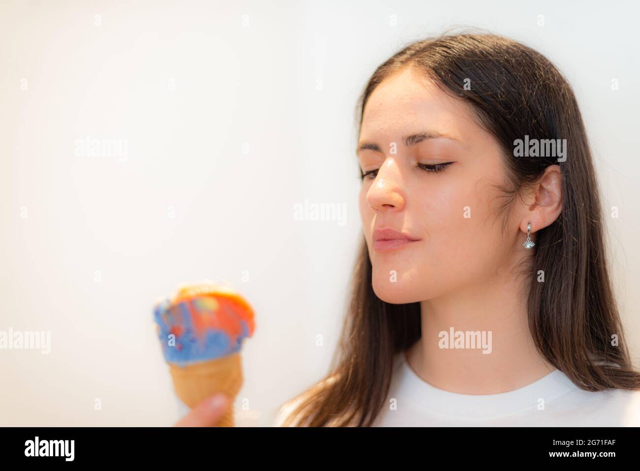 Young Caucasian female focusing at cocktail Ice cream with isolated ...