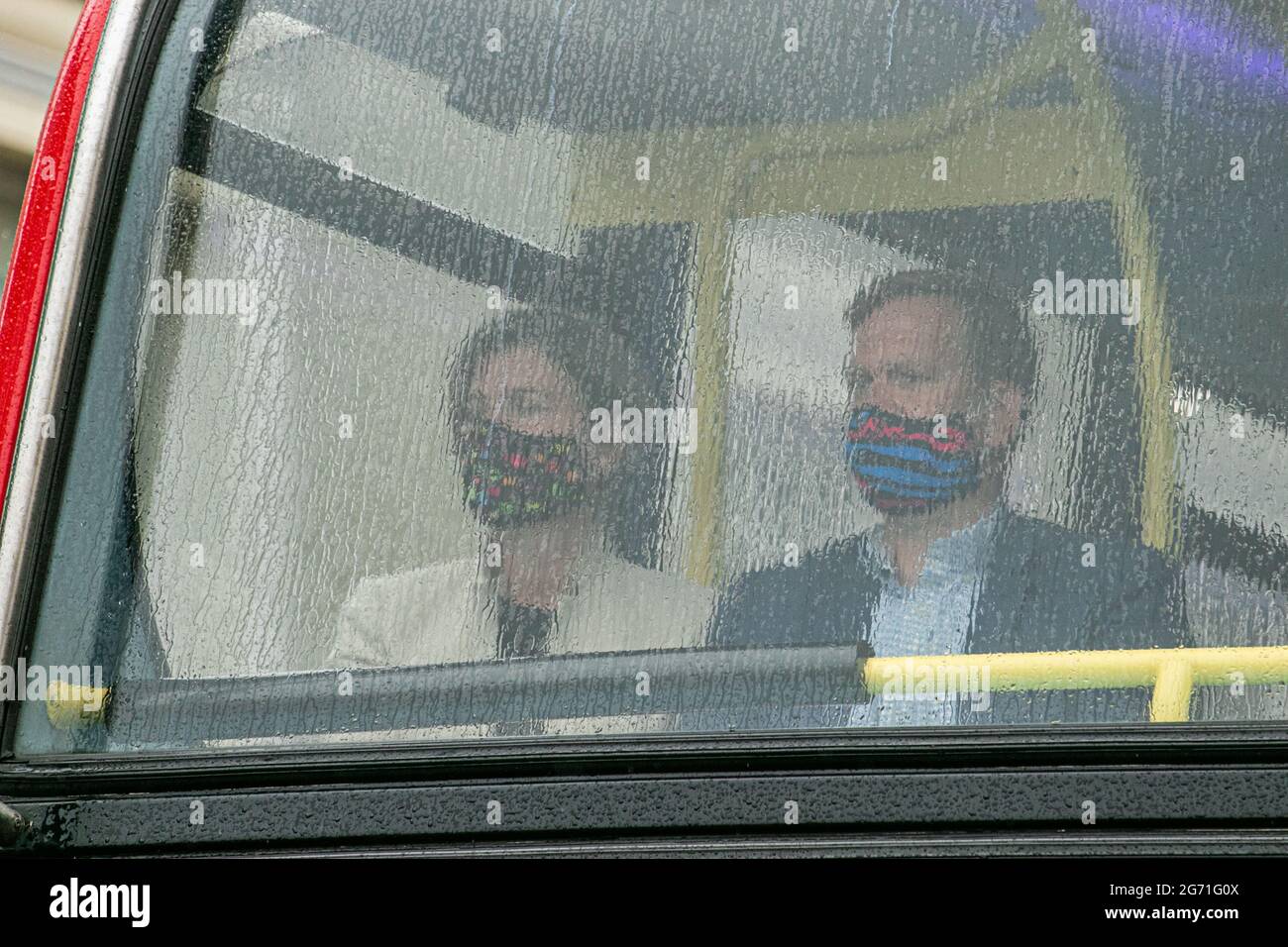 London, UK. 10th July, 2021. Tennis fans sitting behind the window of a ...