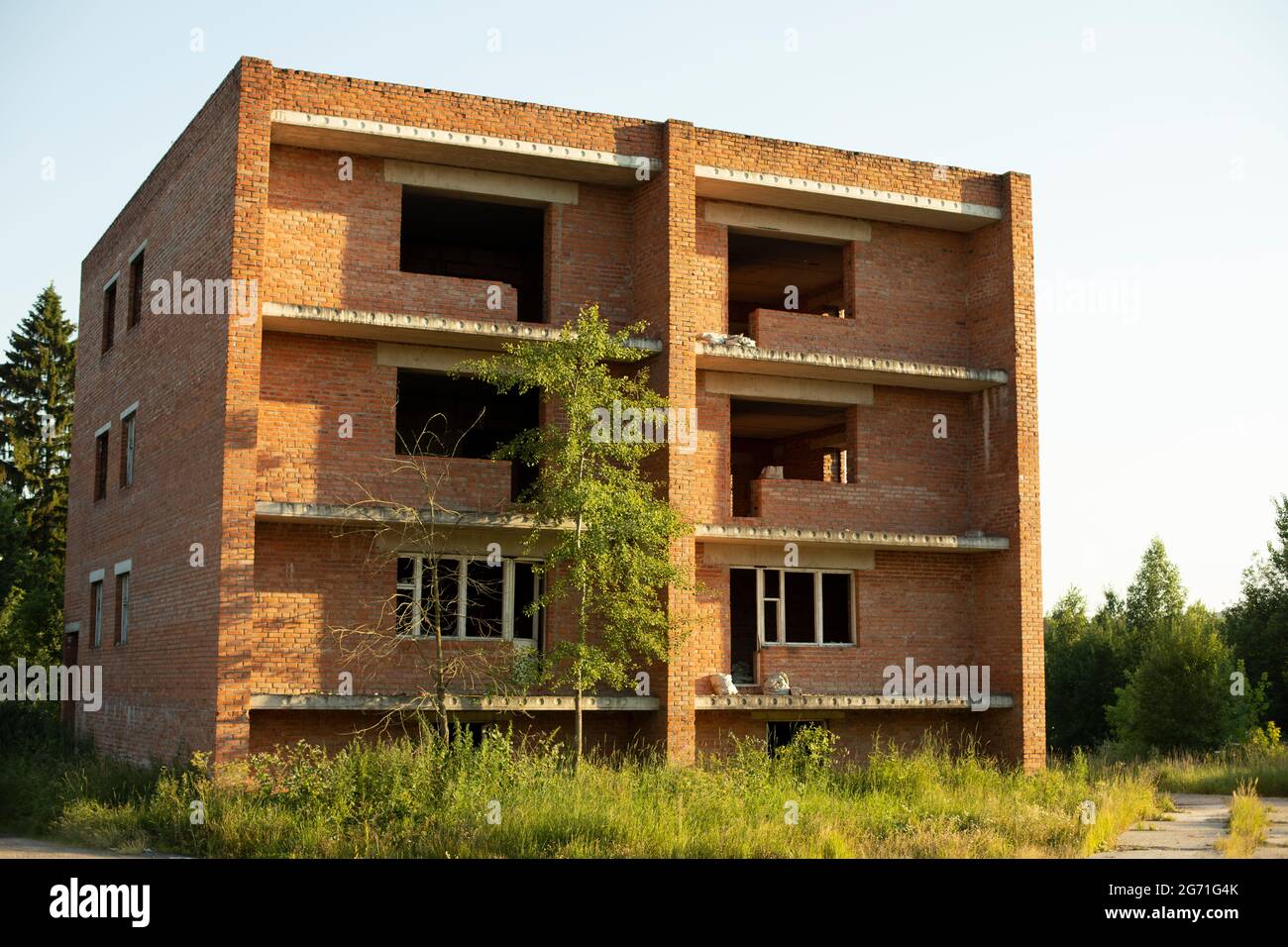Abandoned brick building. Brick building. Two-storey building in summer ...
