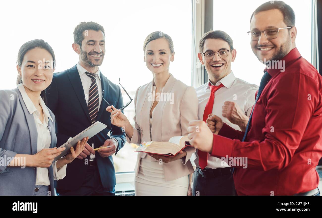Very happy business people in the office smiling at camera Stock Photo ...