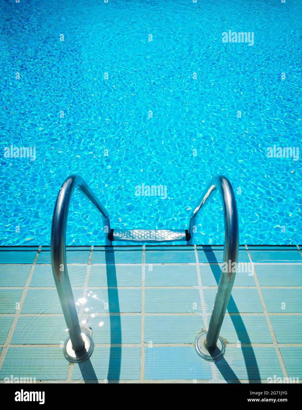 Vertical shot of the swimming pool with clear, blue water. The pool ...
