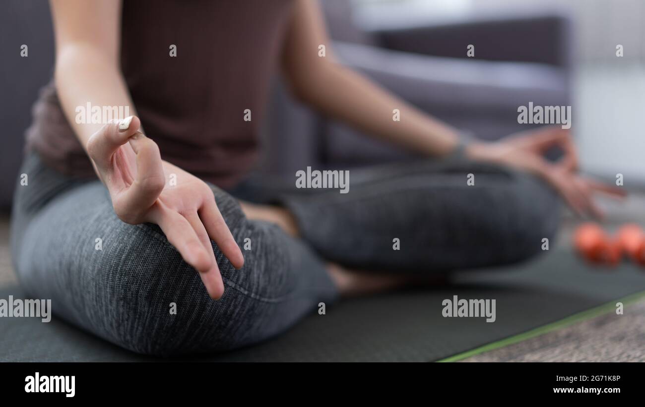 a lively girl doing meditate to keep calm mind and being relaxed as her ...