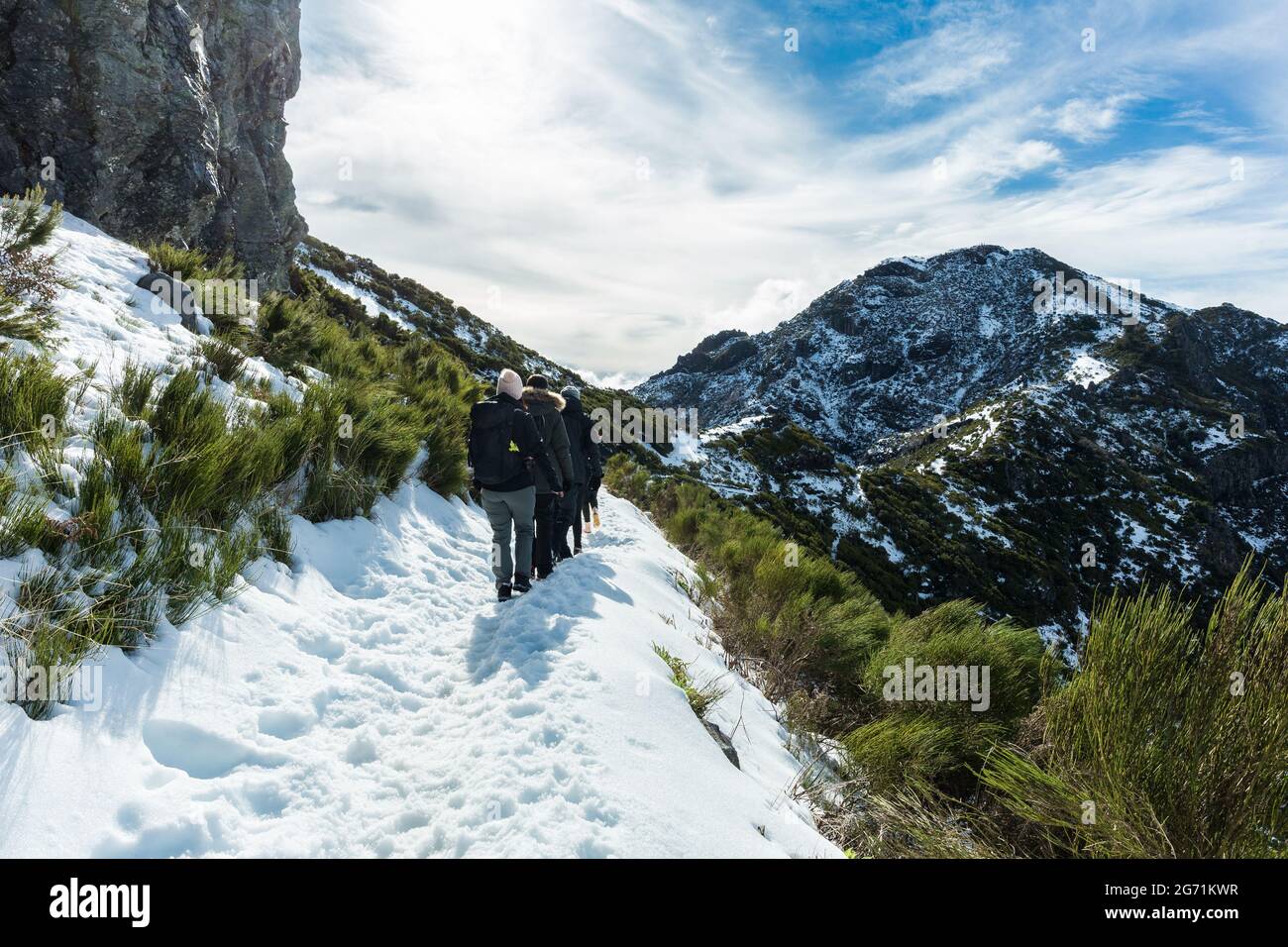 Group of people hiking in Pico Ruivo footpath covered with snow in ...