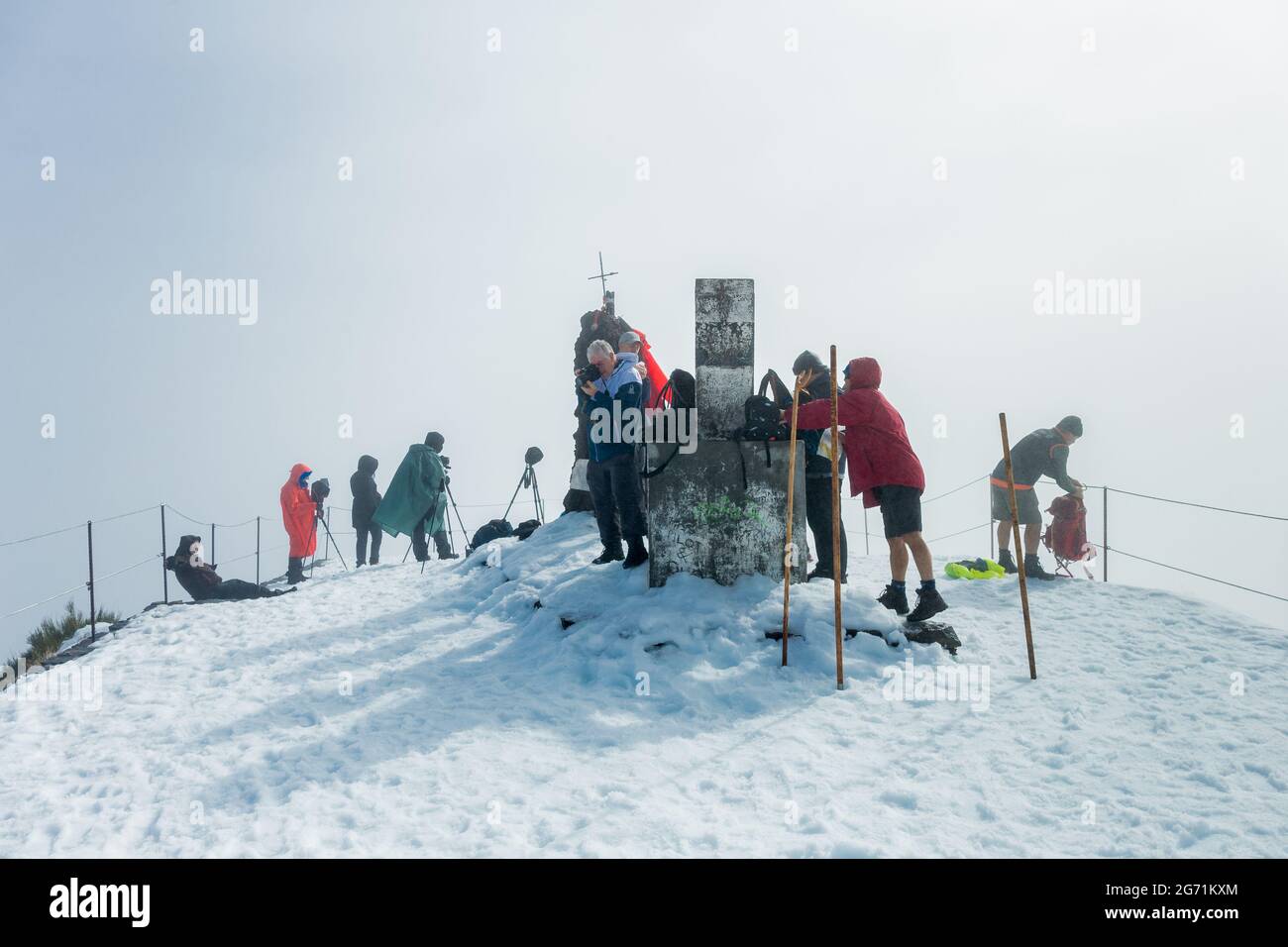 Group of people in the most highest peak of Madeira island covered with ...