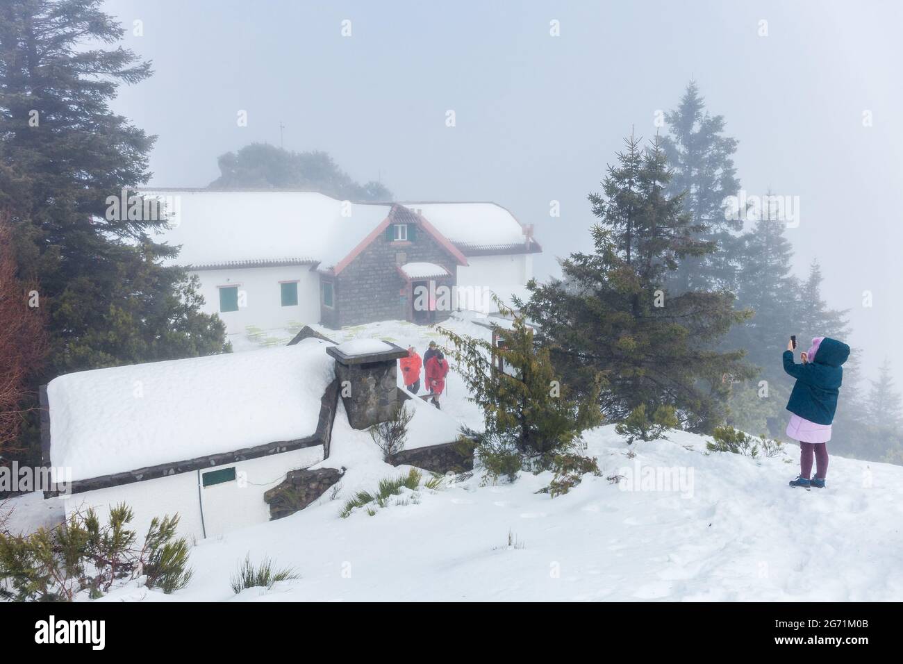 Tourists taking pictures in Pico Ruivo footpath covered with snow in ...