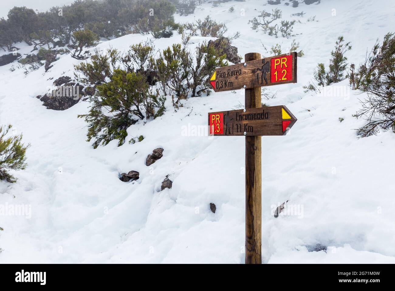 Directional sign plates surrounded by snow in Pico Ruivo footpath in ...