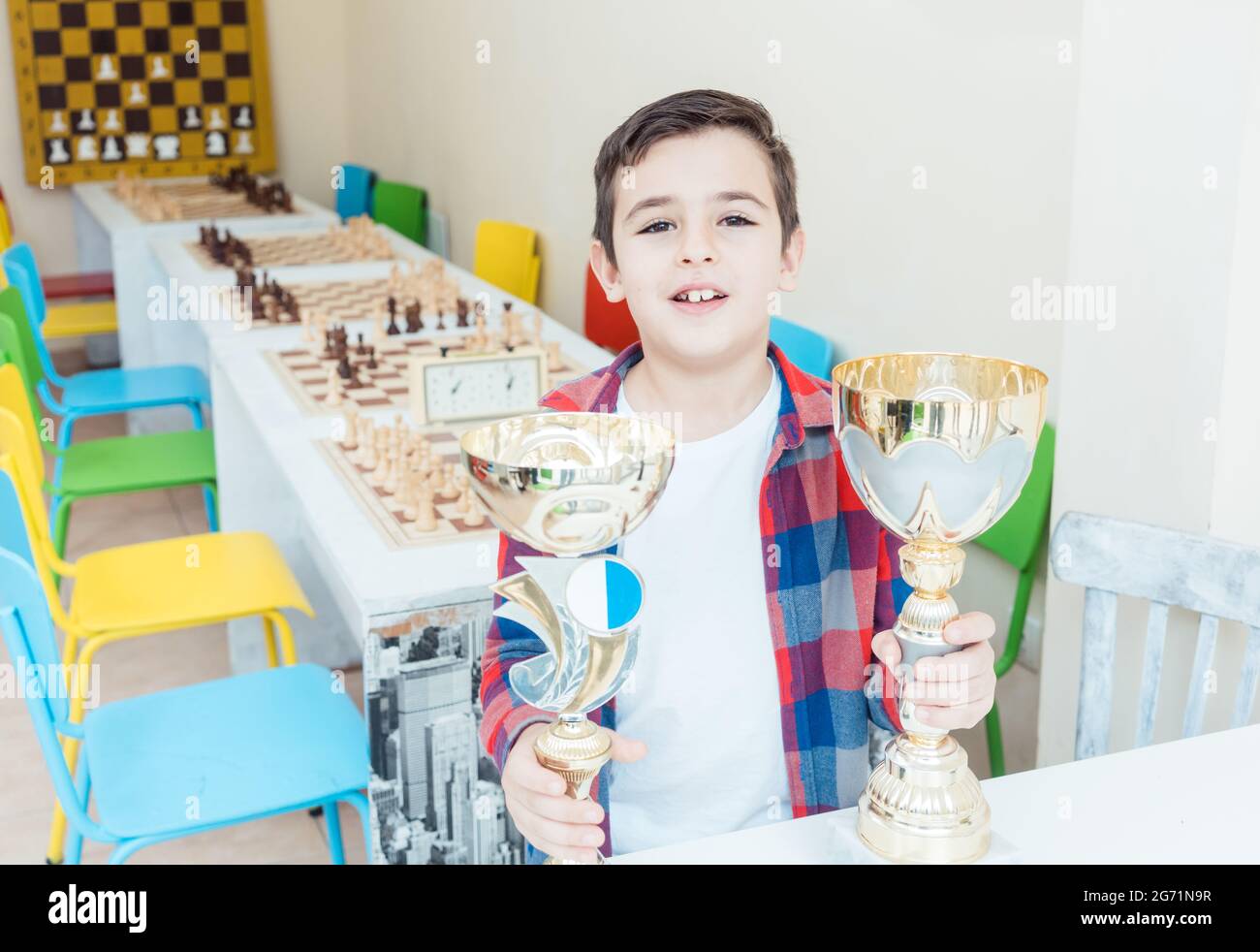 Boy showing trophy he has won in chess tournament in excitement Stock ...