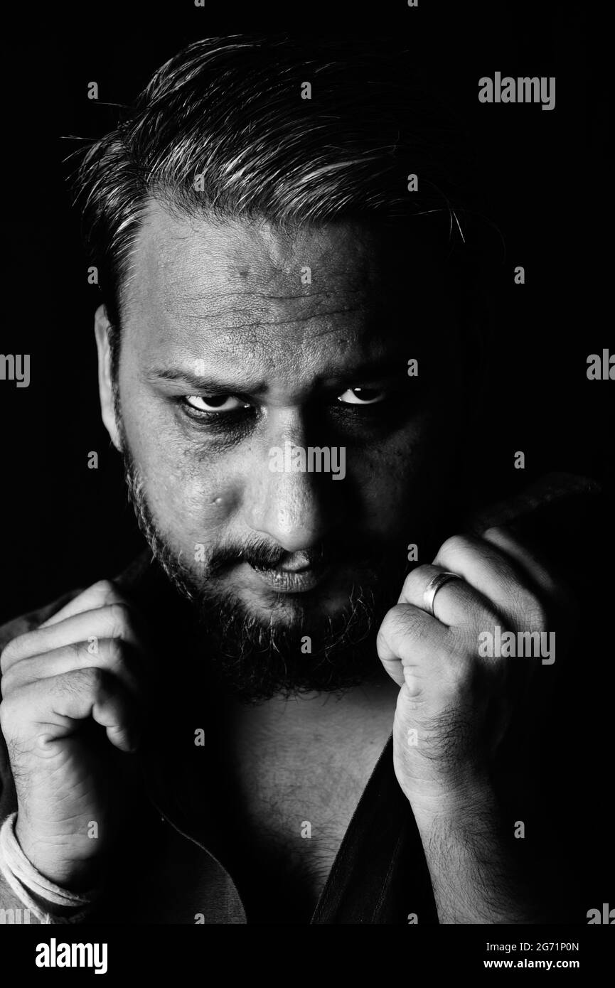 Grayscale portrait of a man with angry eyes showing power with his ...