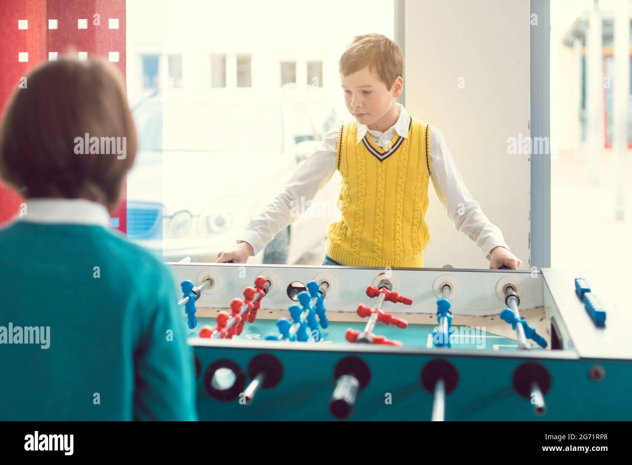 Two boy students in school break playing tabletop football Stock Photo ...