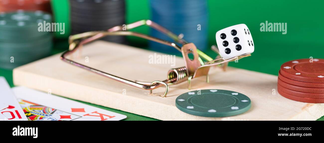 Dice and mousetrap, game trap, on a green background, get into gambling ...