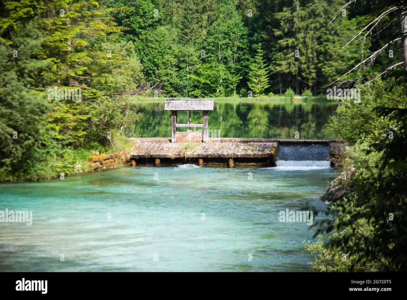 Small dam over a river surrounded by greenery under the sunlight Stock ...