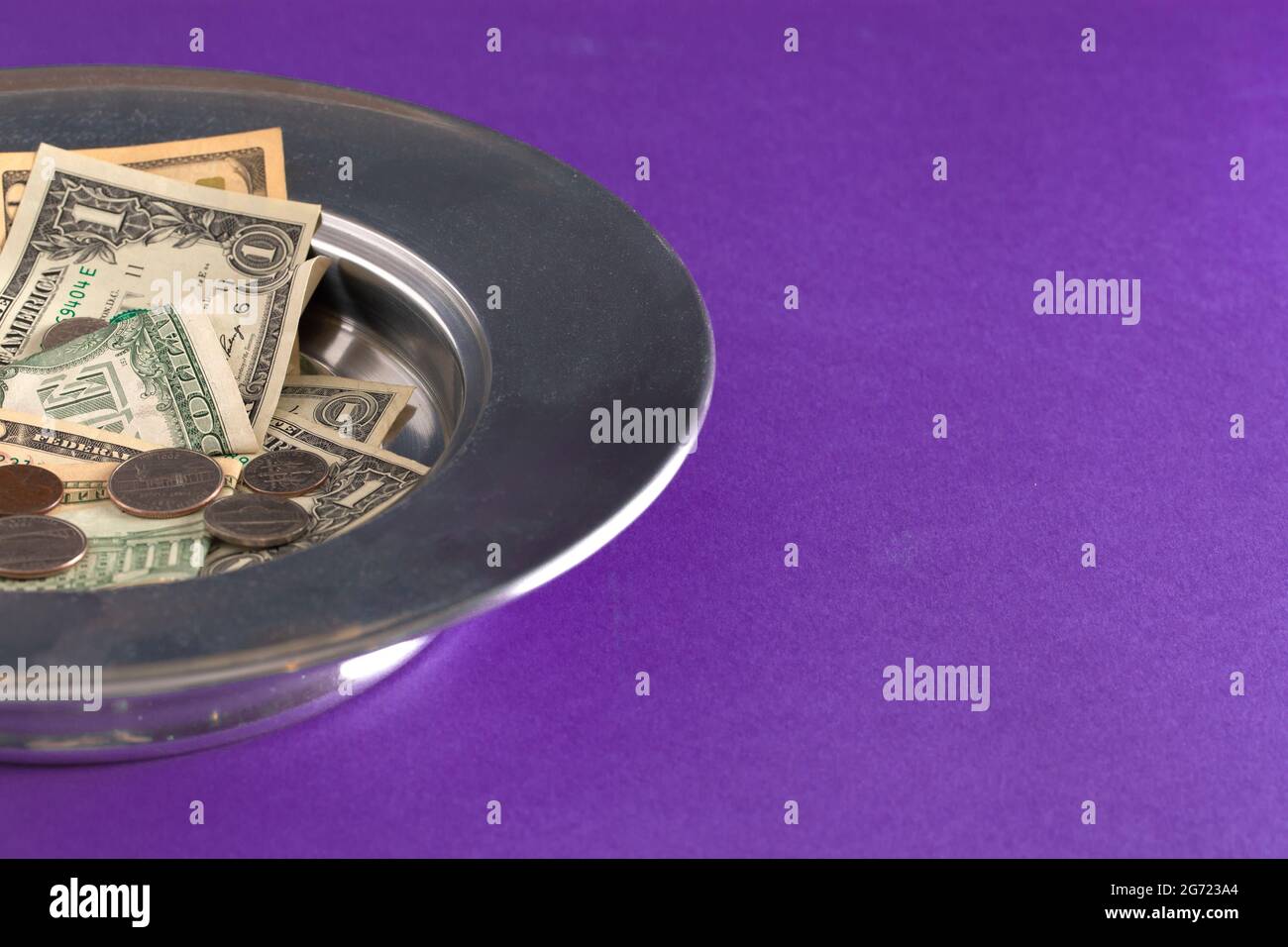 Church Collection or Contribution in a Silver Tray Stock Photo - Alamy