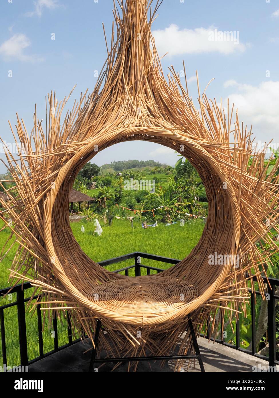 Rattan wicker chair in a form of a circle on a balcony facing the ...