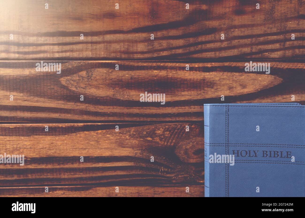 Background with a Bible on a Rustic Wooden Table Stock Photo - Alamy