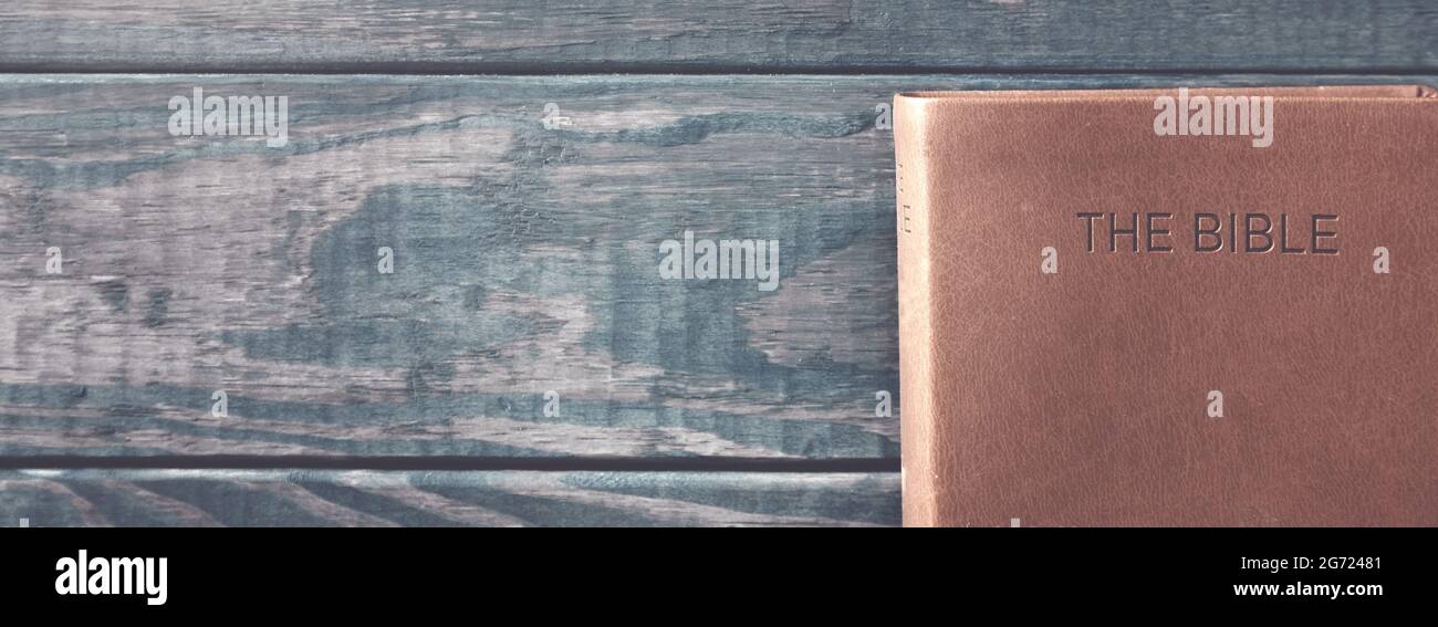 Background with a Bible on a Rustic Wooden Table Stock Photo - Alamy