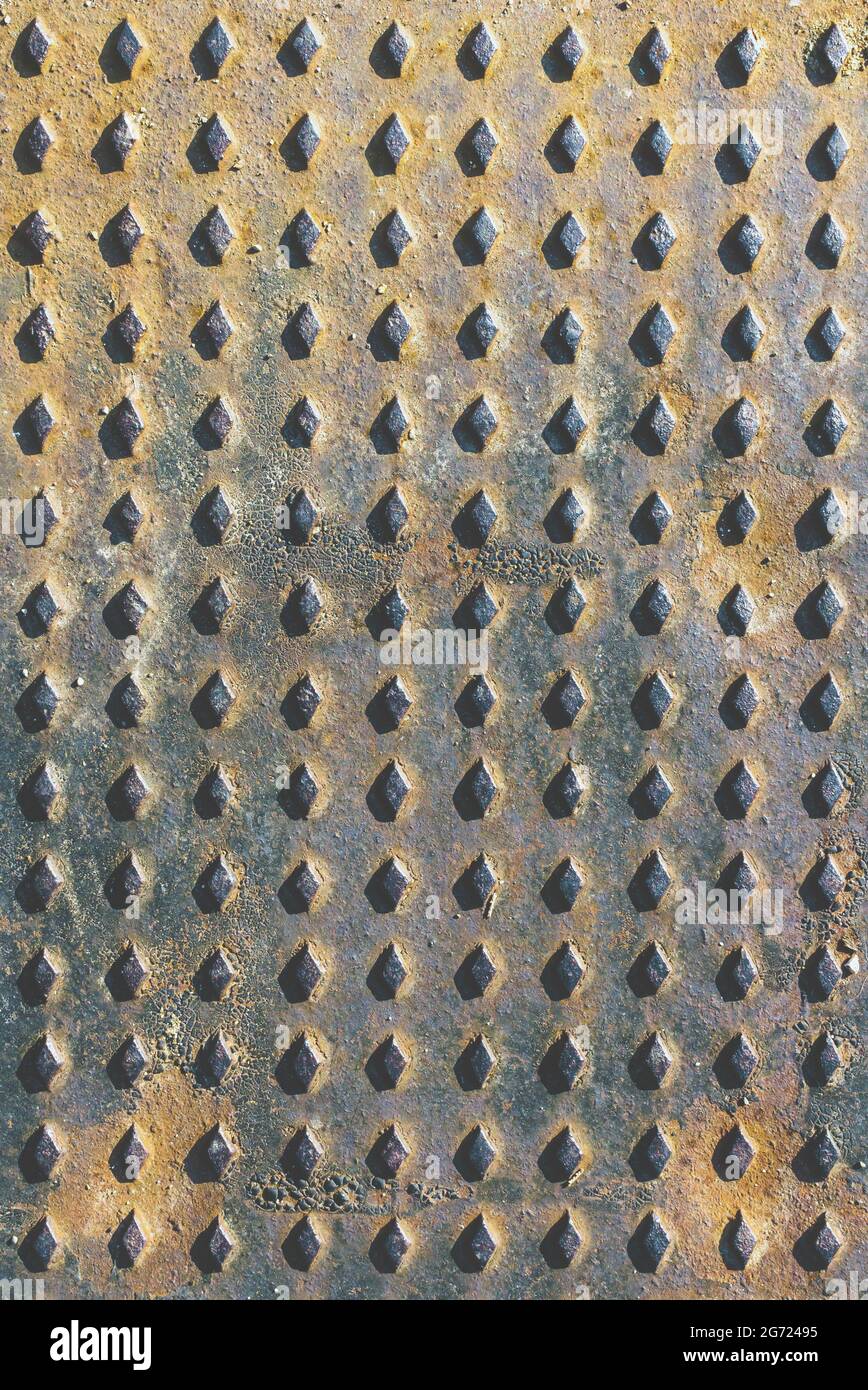 Rusty sewer manhole cover. Geometric pattern on the cover of the sewer ...