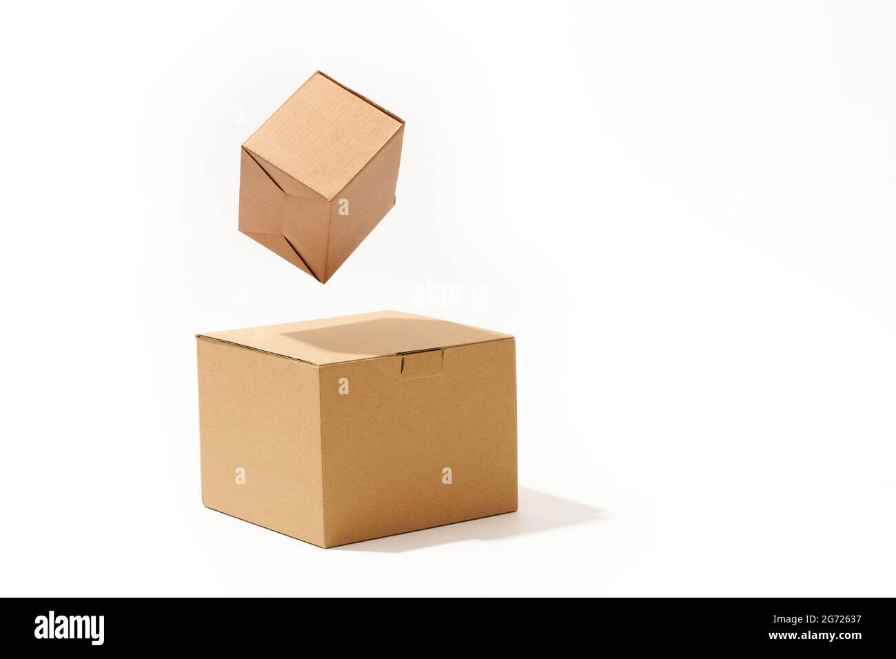 Close-up shot of different shaped cardboard boxes isolated on white ...