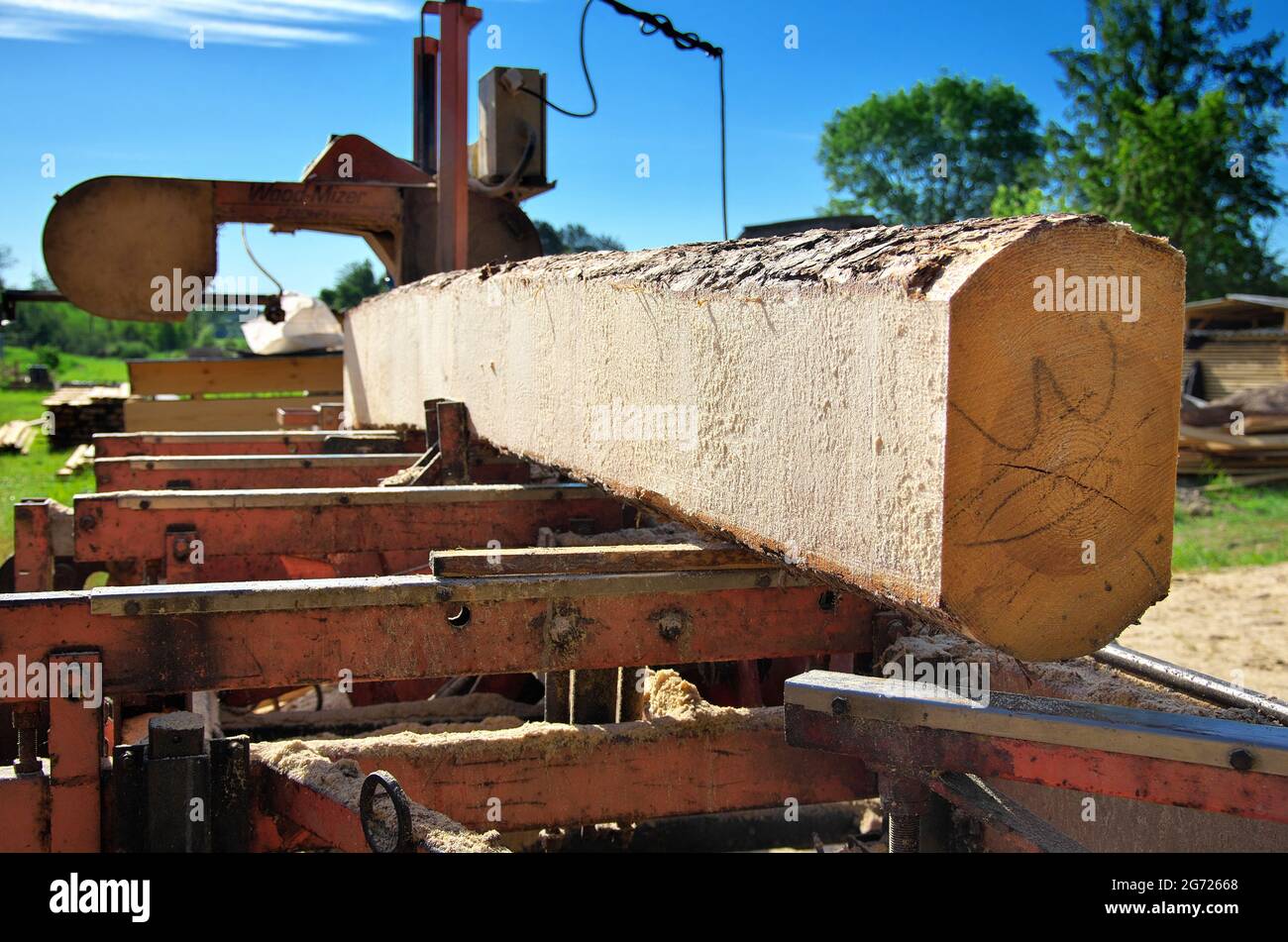 sawing logs on a mobile sawmill. log on the sawmill. preparation for ...