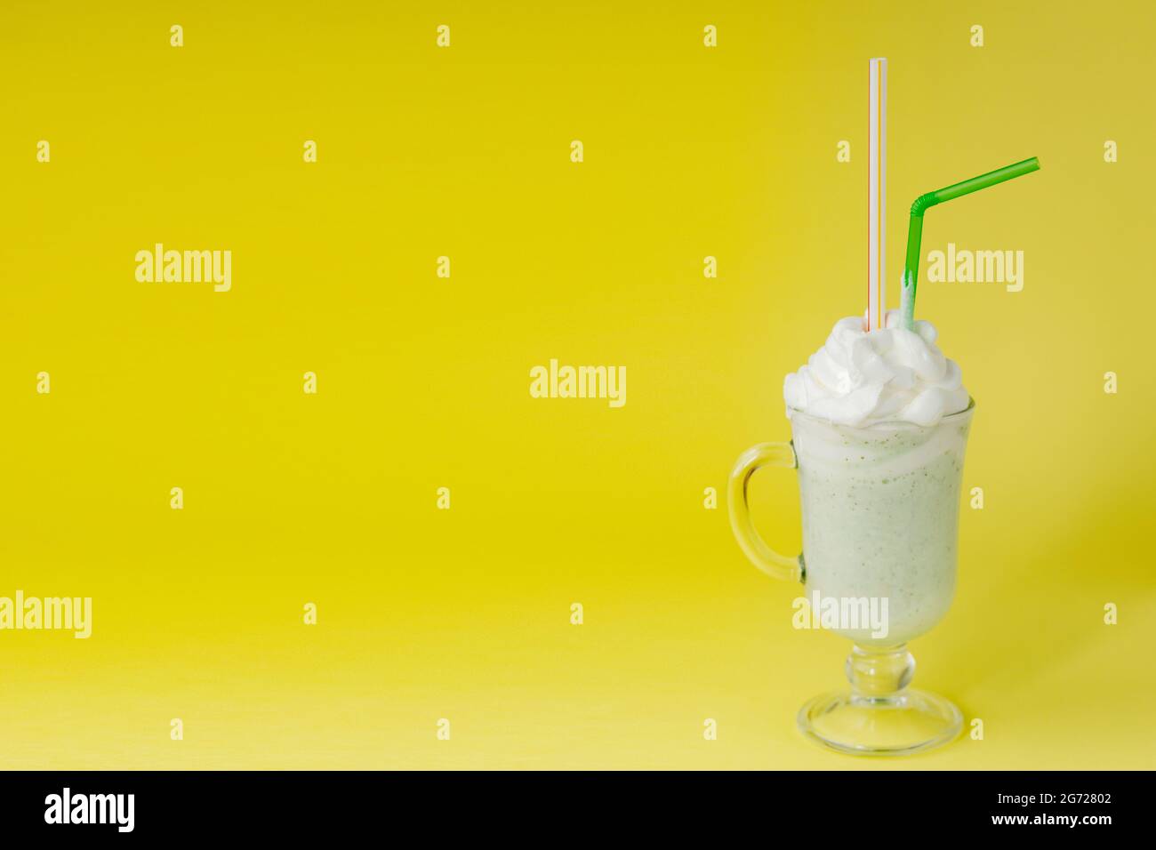 Cold green Peppermint milkshake on a yellow background Stock Photo - Alamy