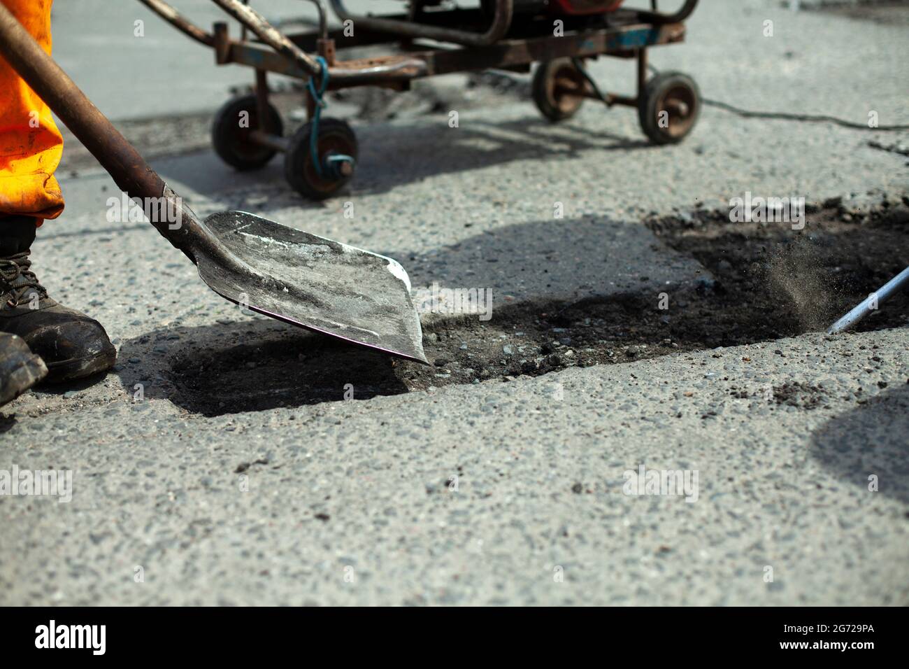 Shovel with asphalt. Repair of the road. Tool for cleaning old asphalt ...