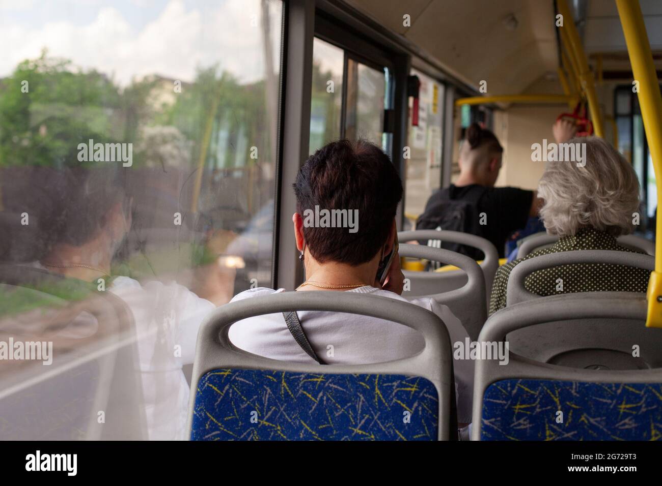 A man sits on a bus. Passenger on public transport. A man goes home ...