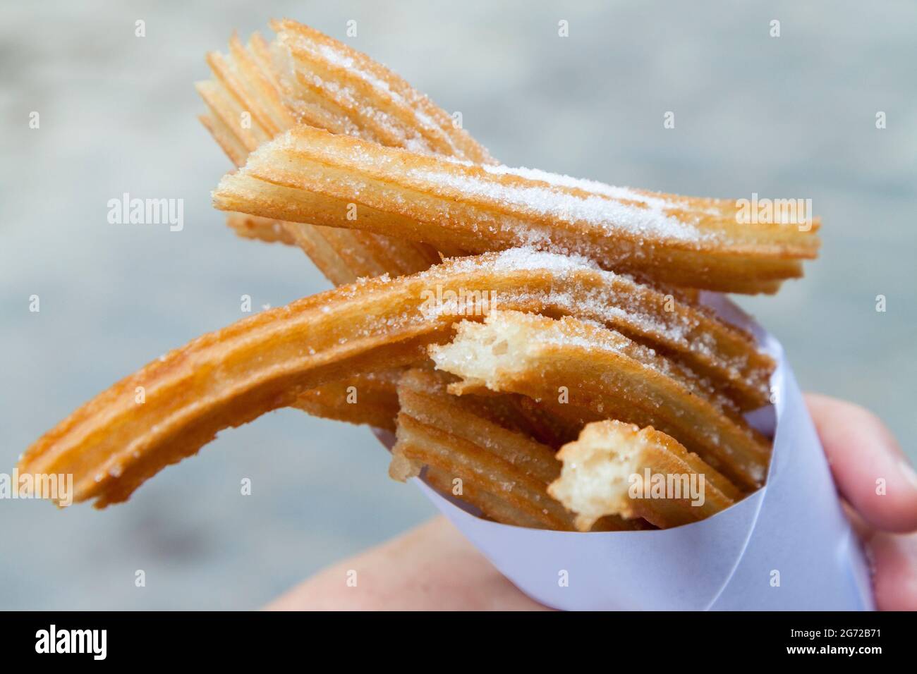 Freshly cooked churros, sprinkled with sugar and piled up high in a ...