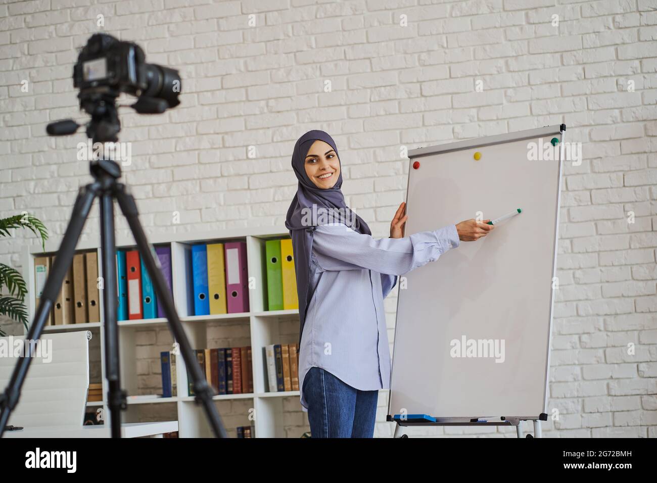 Arabian business woman explaining something and pointing at a ...