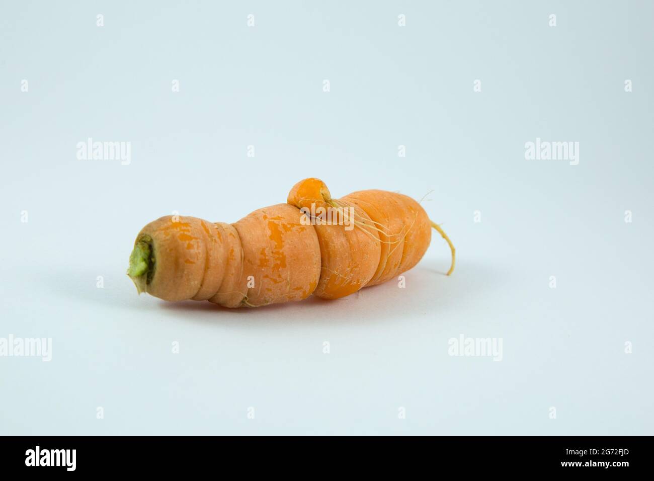 Isolated funny carrot with roots on a white background Stock Photo - Alamy